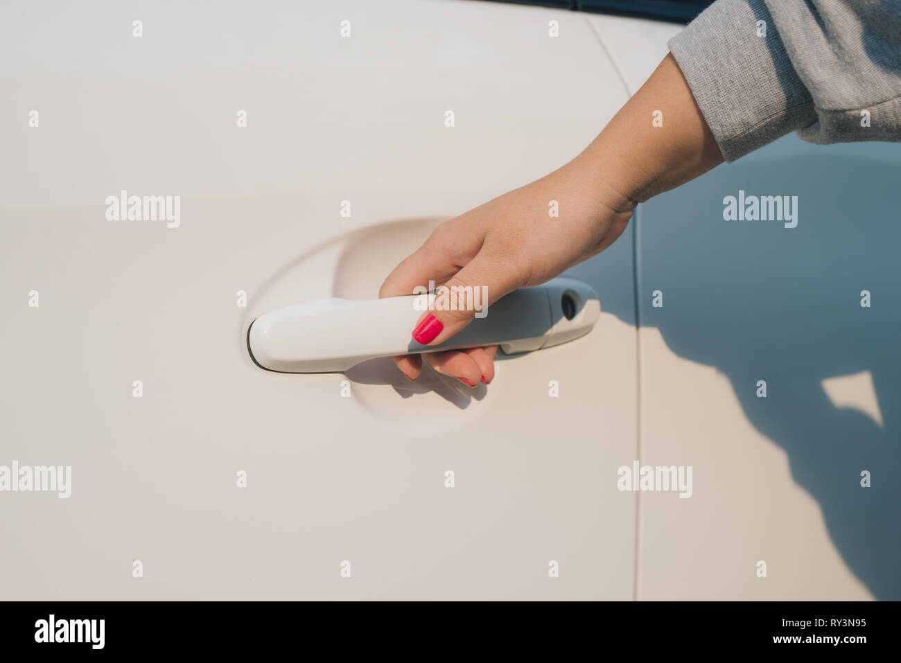 Close up of a female hand opening a car door Stock Photo - Alamy