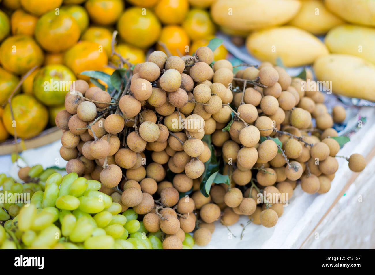 Bunch of fresh longan fruits on local market. Popular lao sweet fruits ...