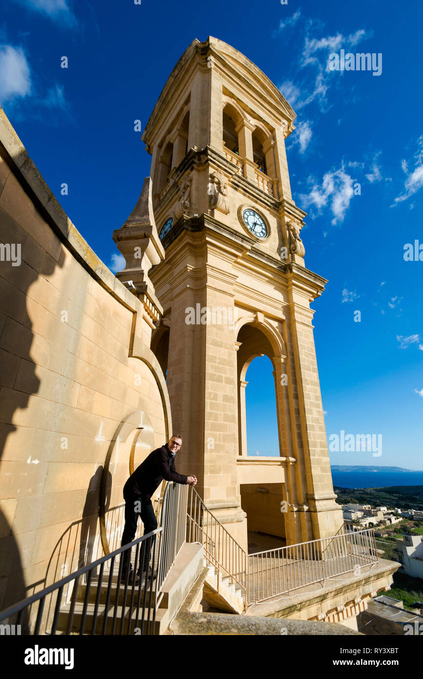 Tourist on clock tower on Church of Saint John The Baptis on Gozo ...