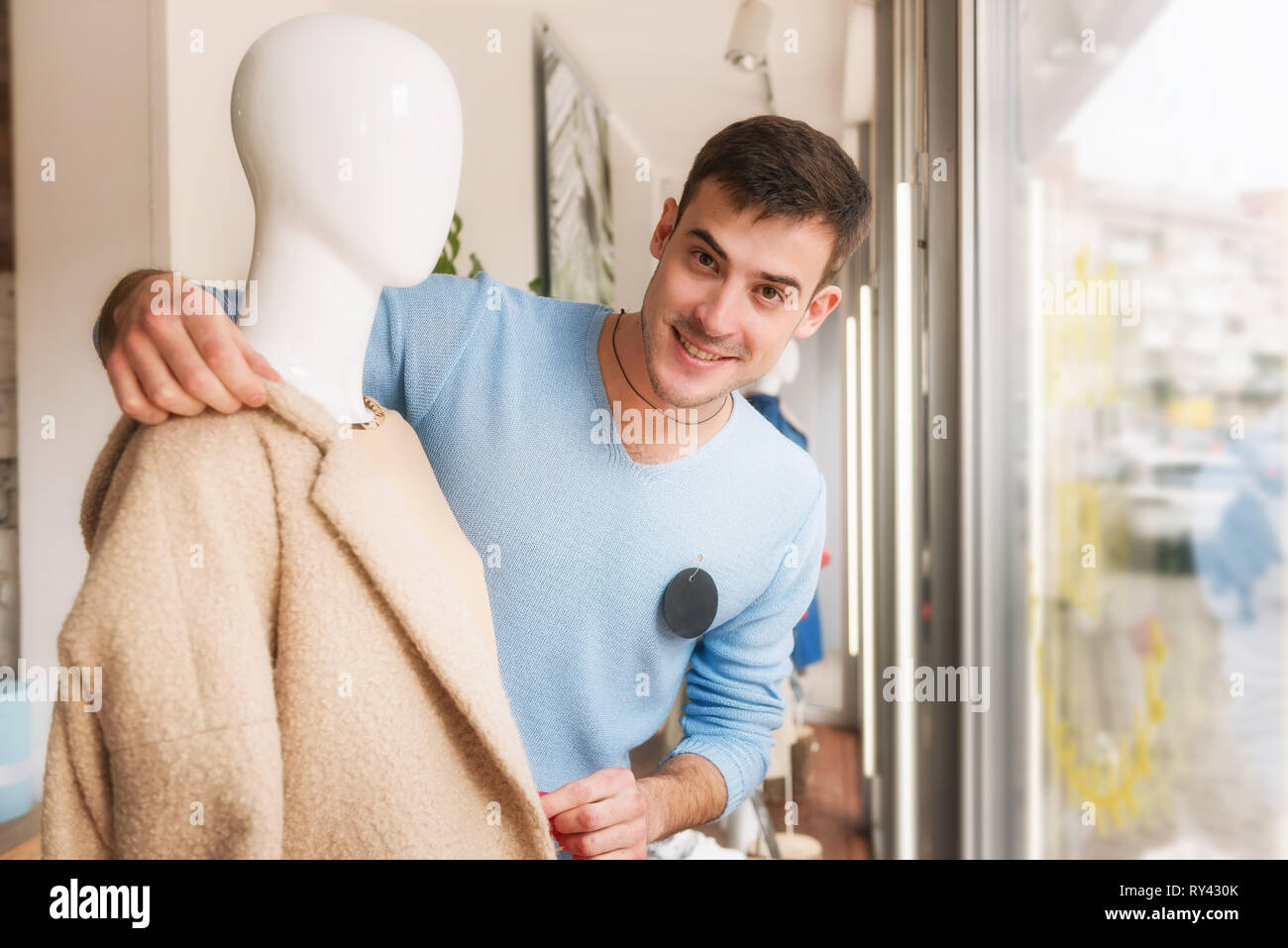 Man putting on coat hi-res stock photography and images - Alamy