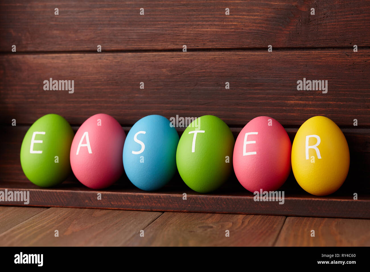 Painted eggs with letters arranged in word Easter Stock Photo - Alamy