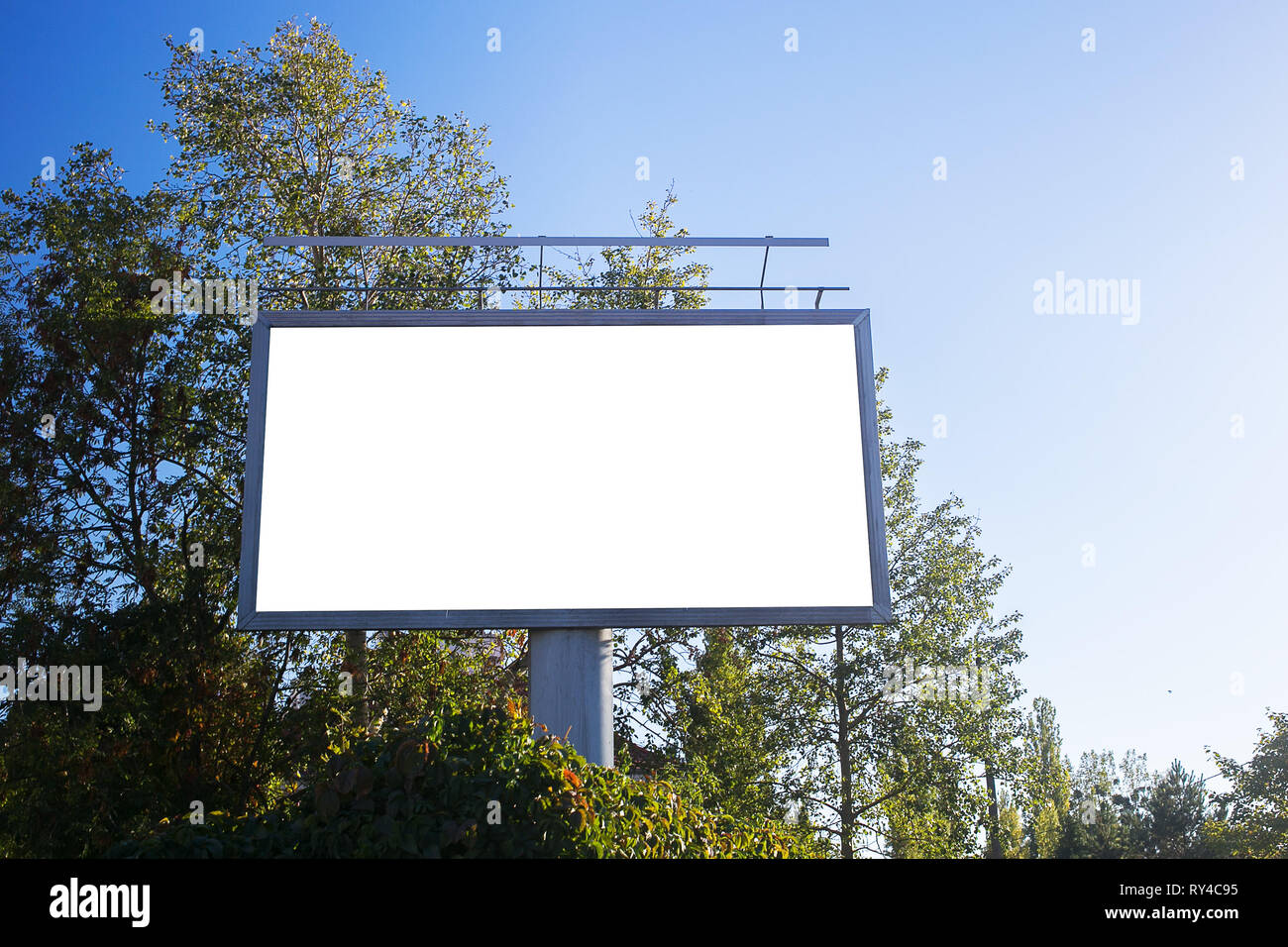Blank billboard in a green scenery with a bright blue sky Stock Photo ...