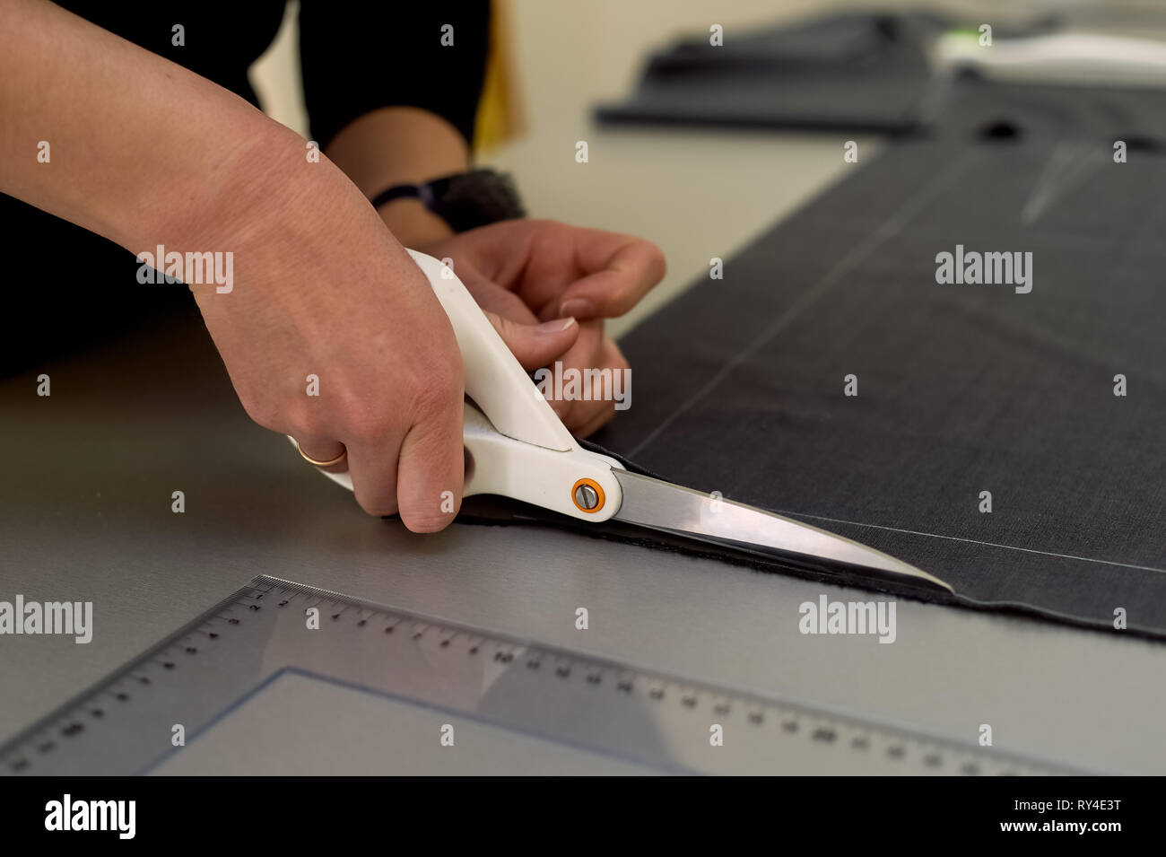 Master cuts fabric. Nesting. Suiting fabric marked with white chalk ...