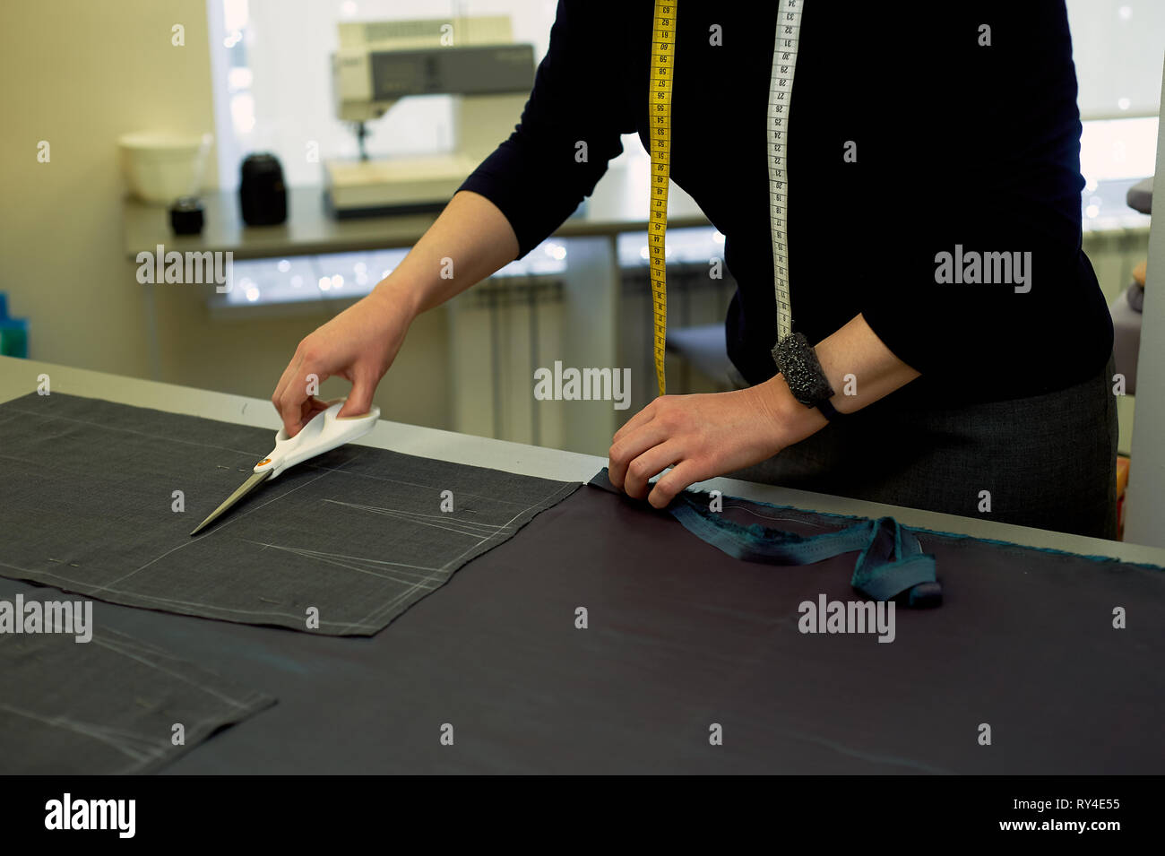 Master cuts fabric. Nesting. Suiting fabric marked with white chalk ...