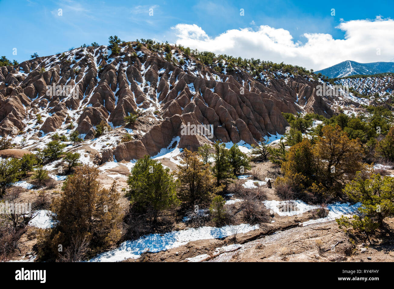Snow dusted unusual Bentonite clay rock formations created by erosion ...