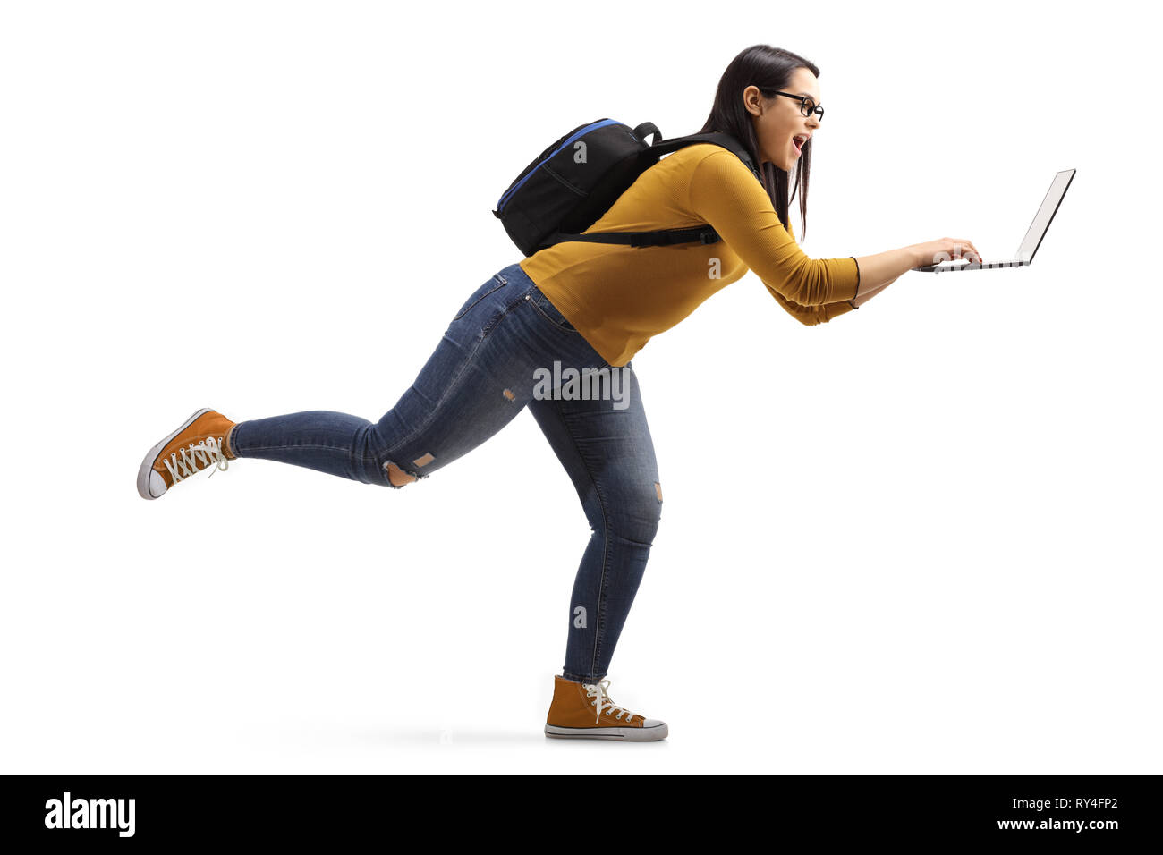 Full length profile shot of a female student running with a laptop ...