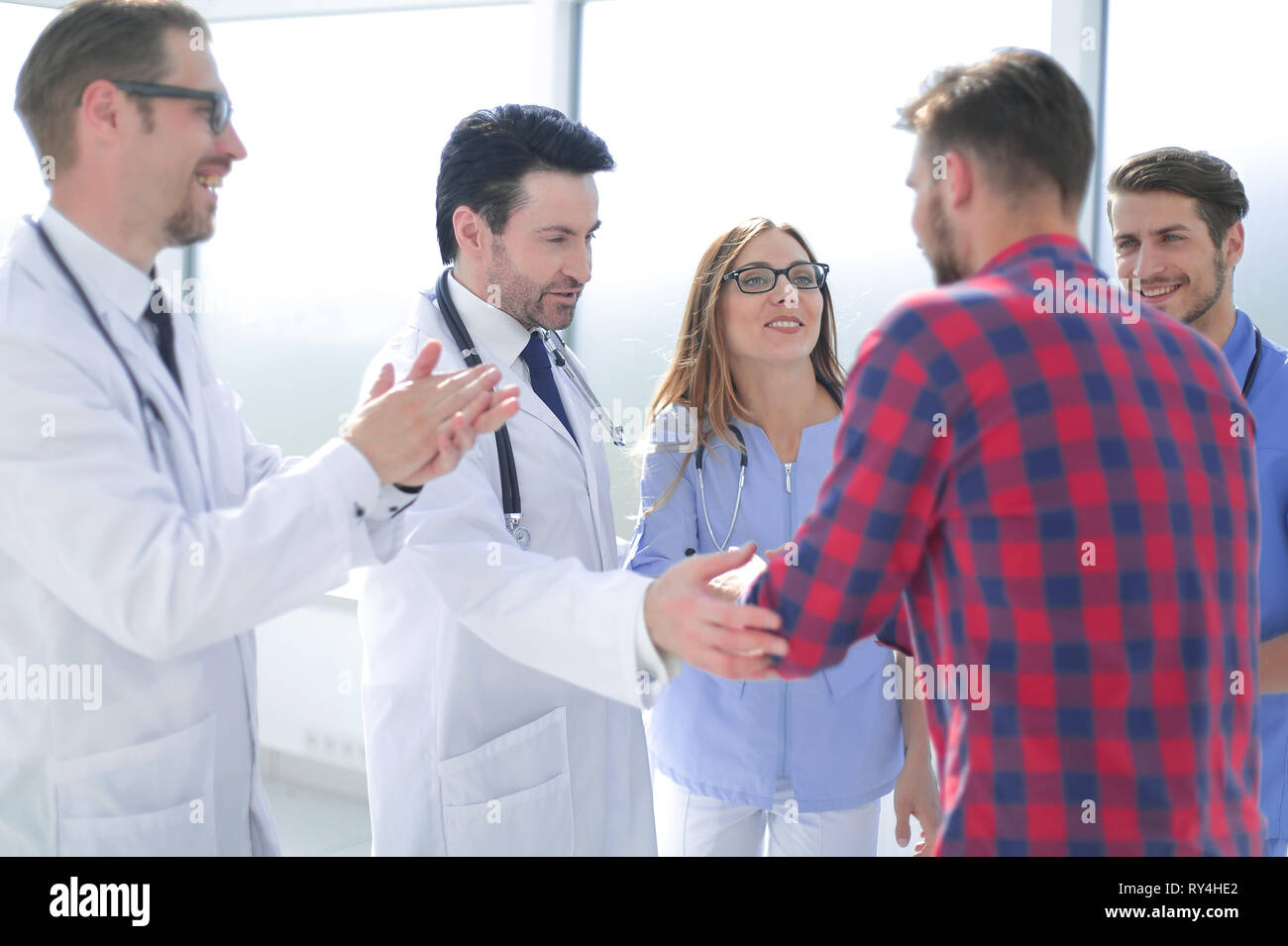 friendly male medical doctor greeting patient Stock Photo - Alamy