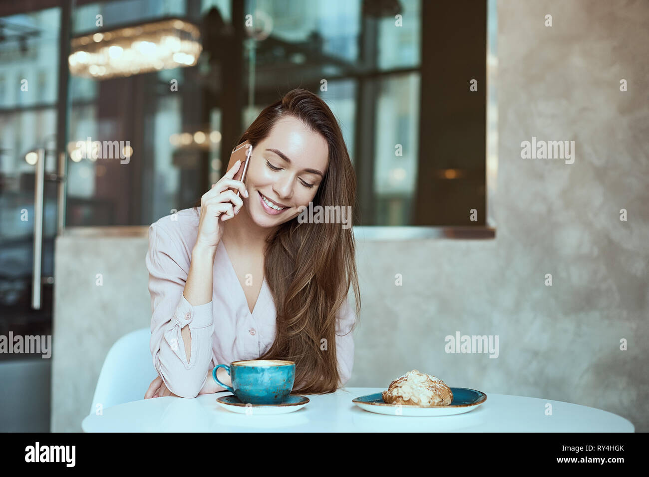 Portrait of beautiful girl using her mobile phone in cafe Stock Photo ...