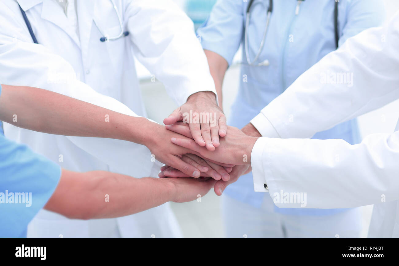doctors holding hands together at hospital Stock Photo - Alamy