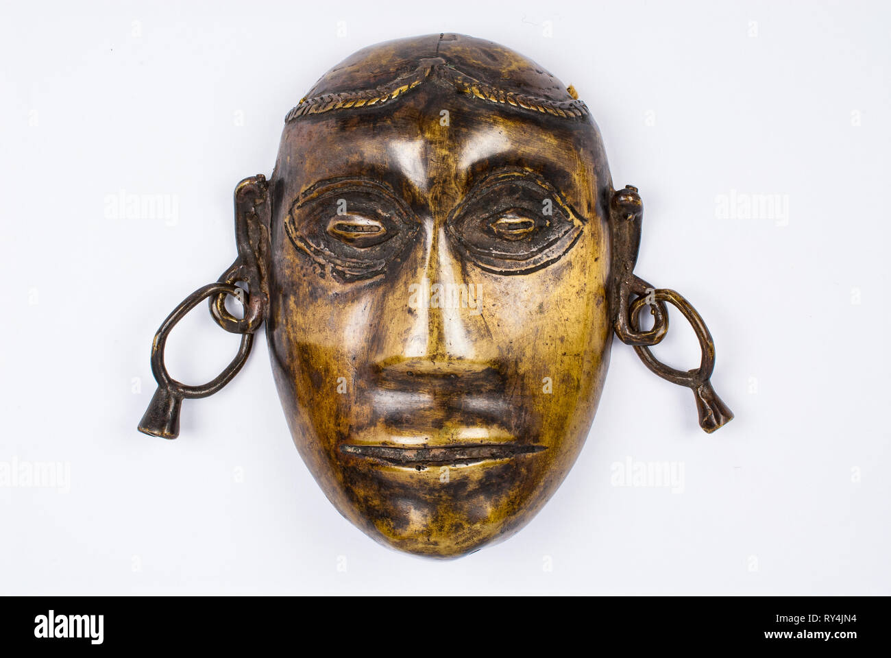 Close-up of a Naga tribal face in bronze from the Nagaland region ...