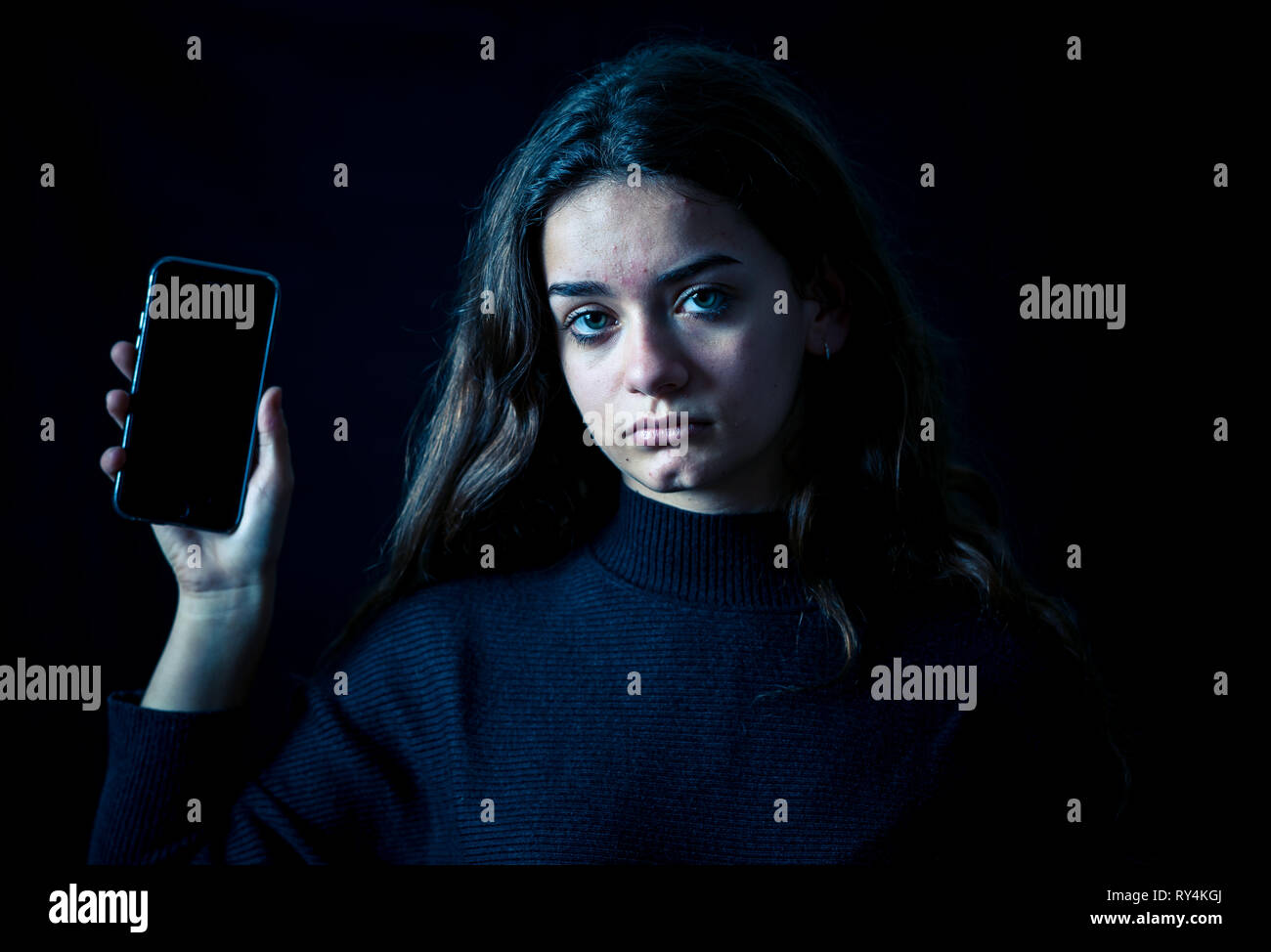 Scared upset girl bullied online suffering harassment crying feeling ...