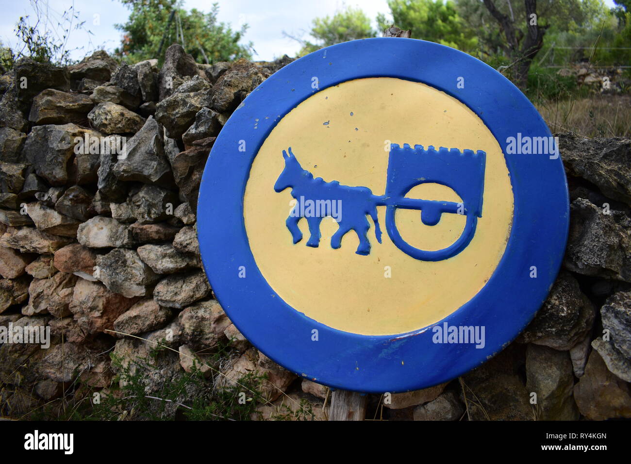 Warning sign in blue and yellow Attention donkey carts on a spanish ...