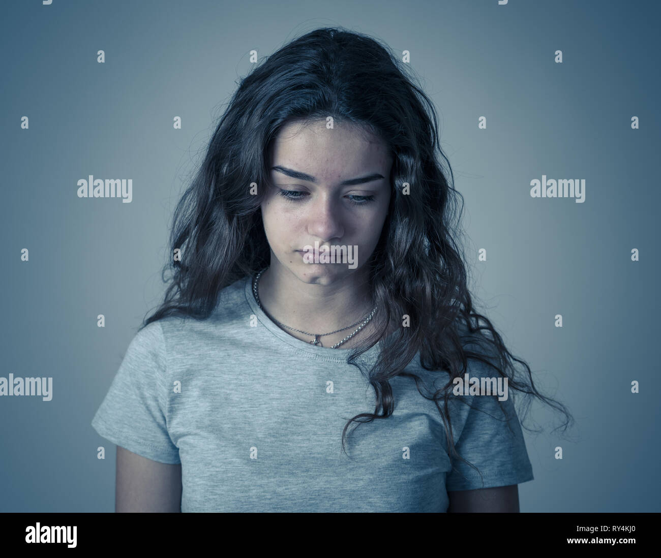 Portrait of sad young teen girl feeling unhappy, miserable and ...