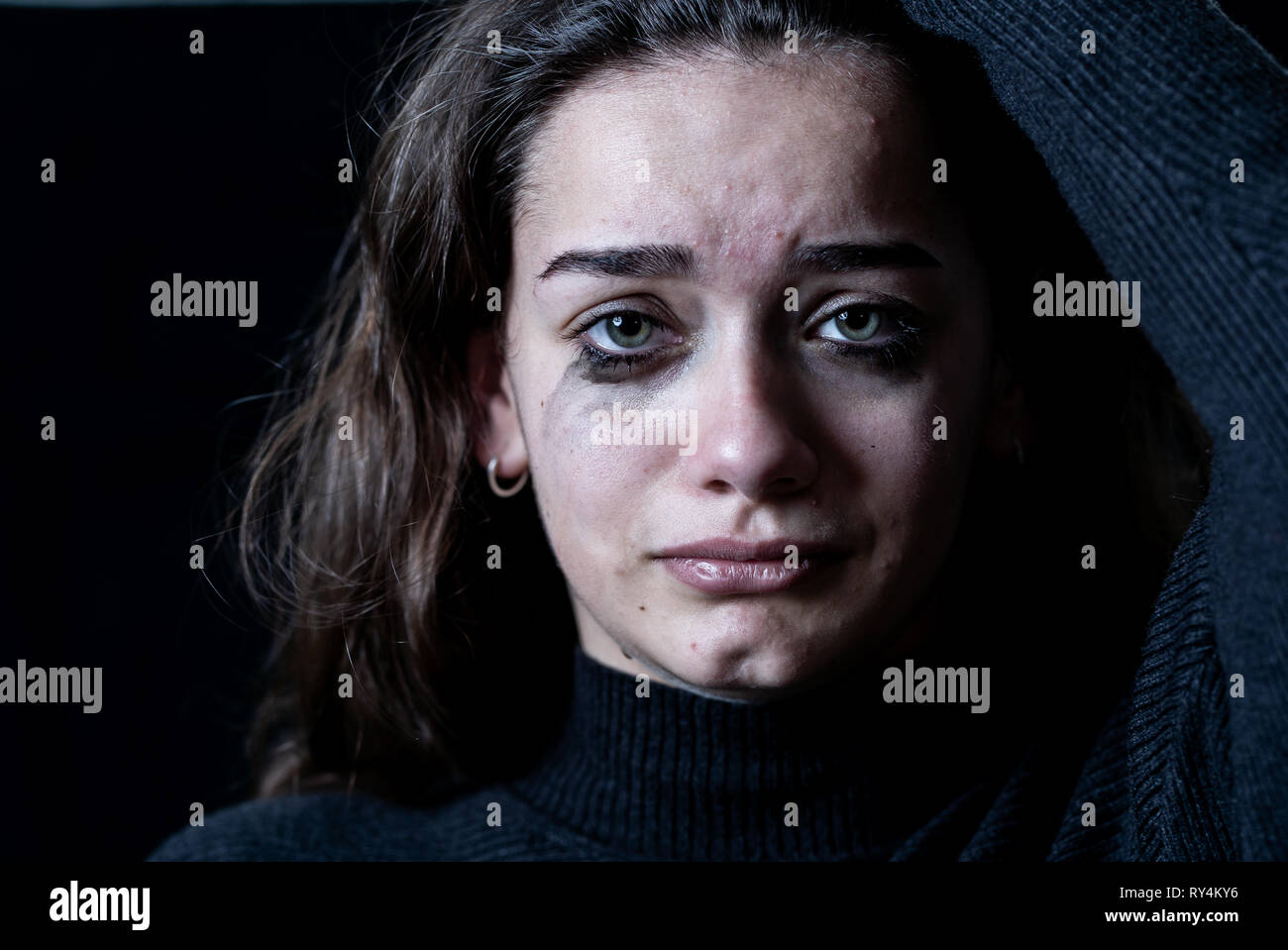 Dramatic closeup portrait of young scared, depressed girl crying alone ...