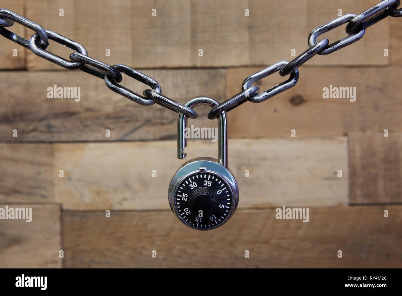 Security Series Chained Black Padlock on a Wooden patterned background ...