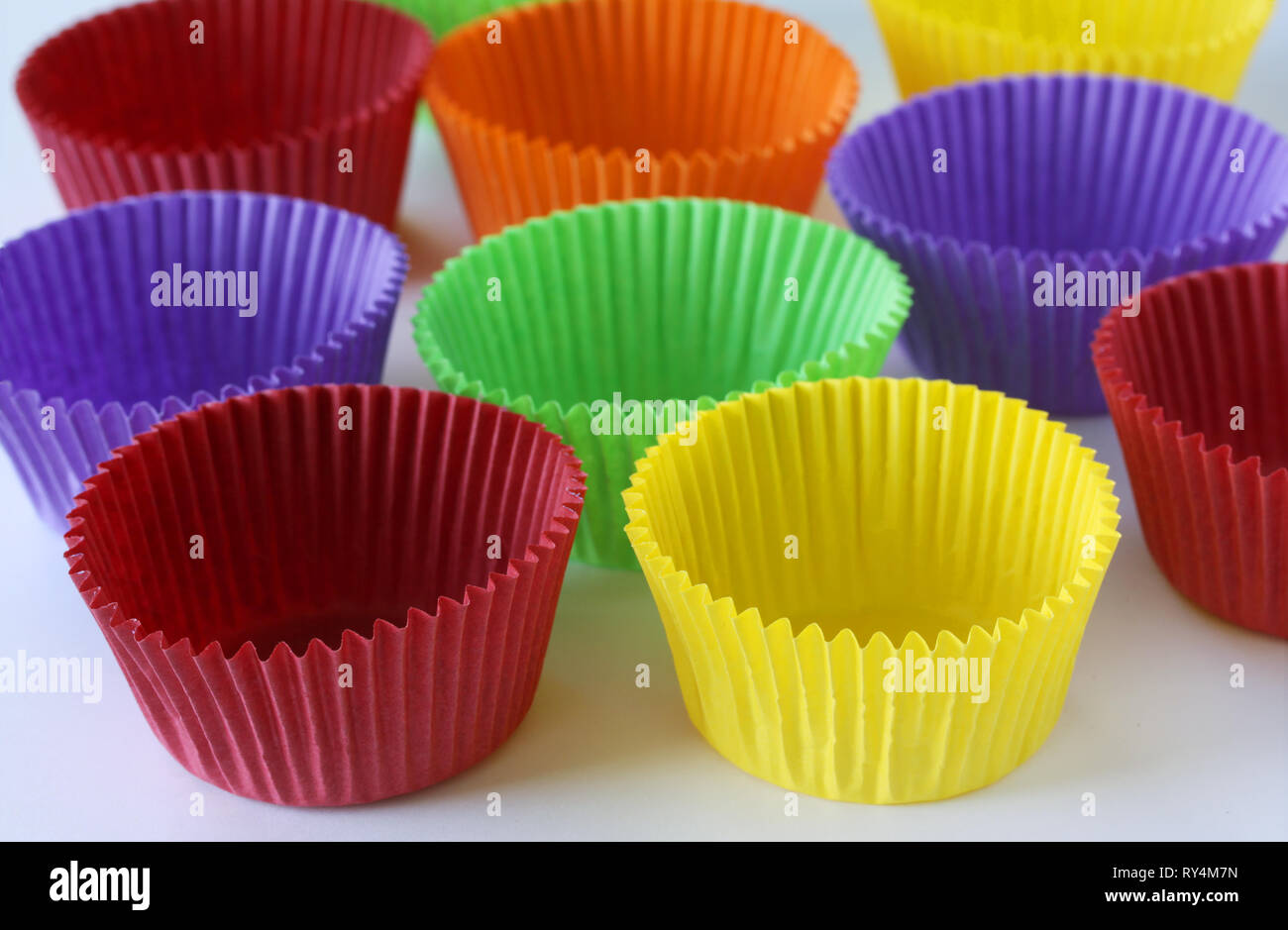 Colorful empty paper forms capsules for muffins and cupcakes on white ...