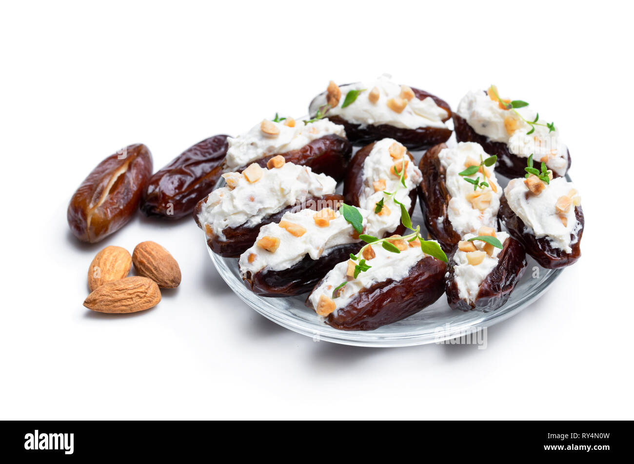 Dates stuffed with cream cheese and almonds isolated on white Stock ...