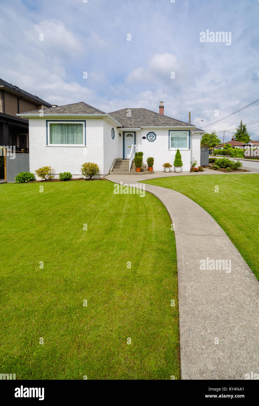 Main entrance of residential house with concrete walkway over the front ...