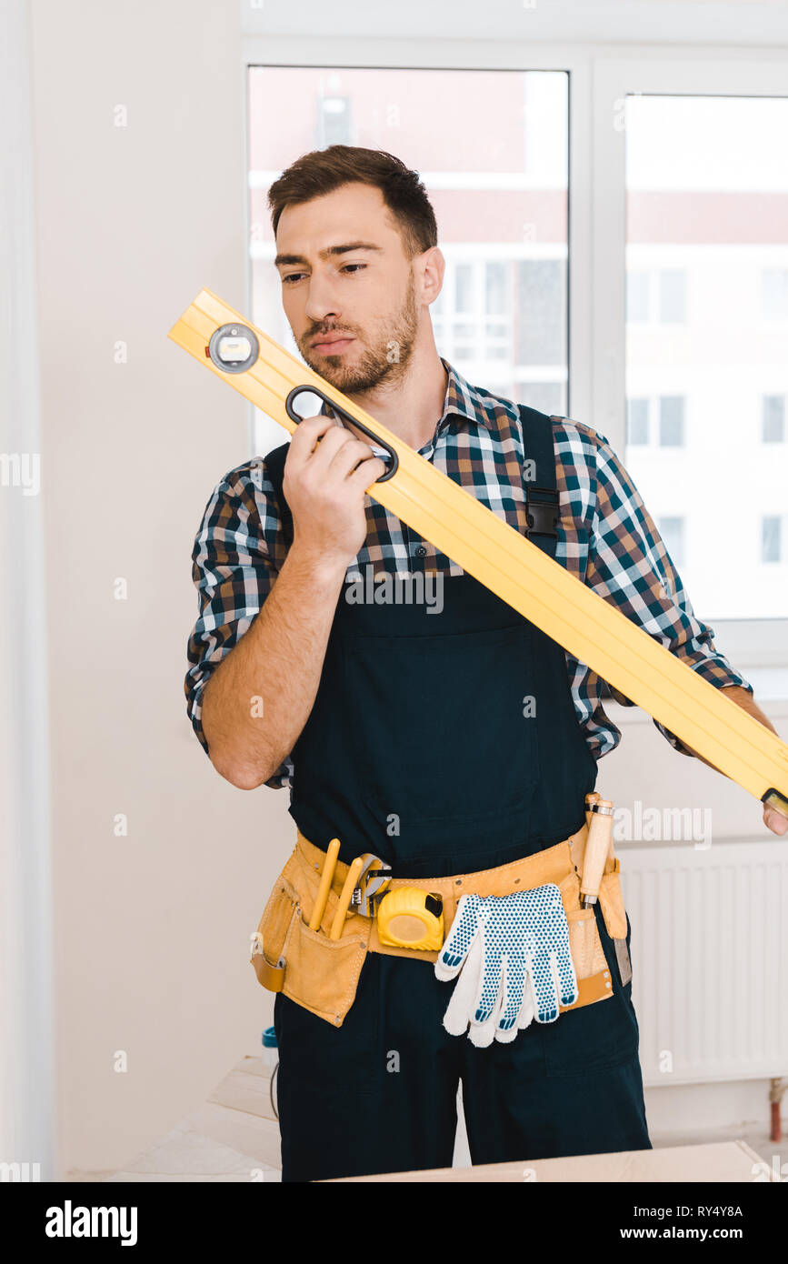 Handsome handyman looking measuring hi-res stock photography and images ...