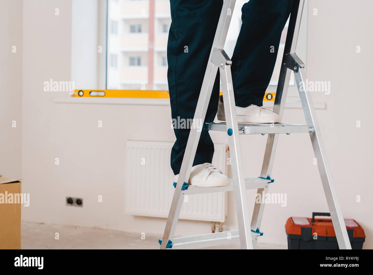Man standing on ladder hi-res stock photography and images - Alamy