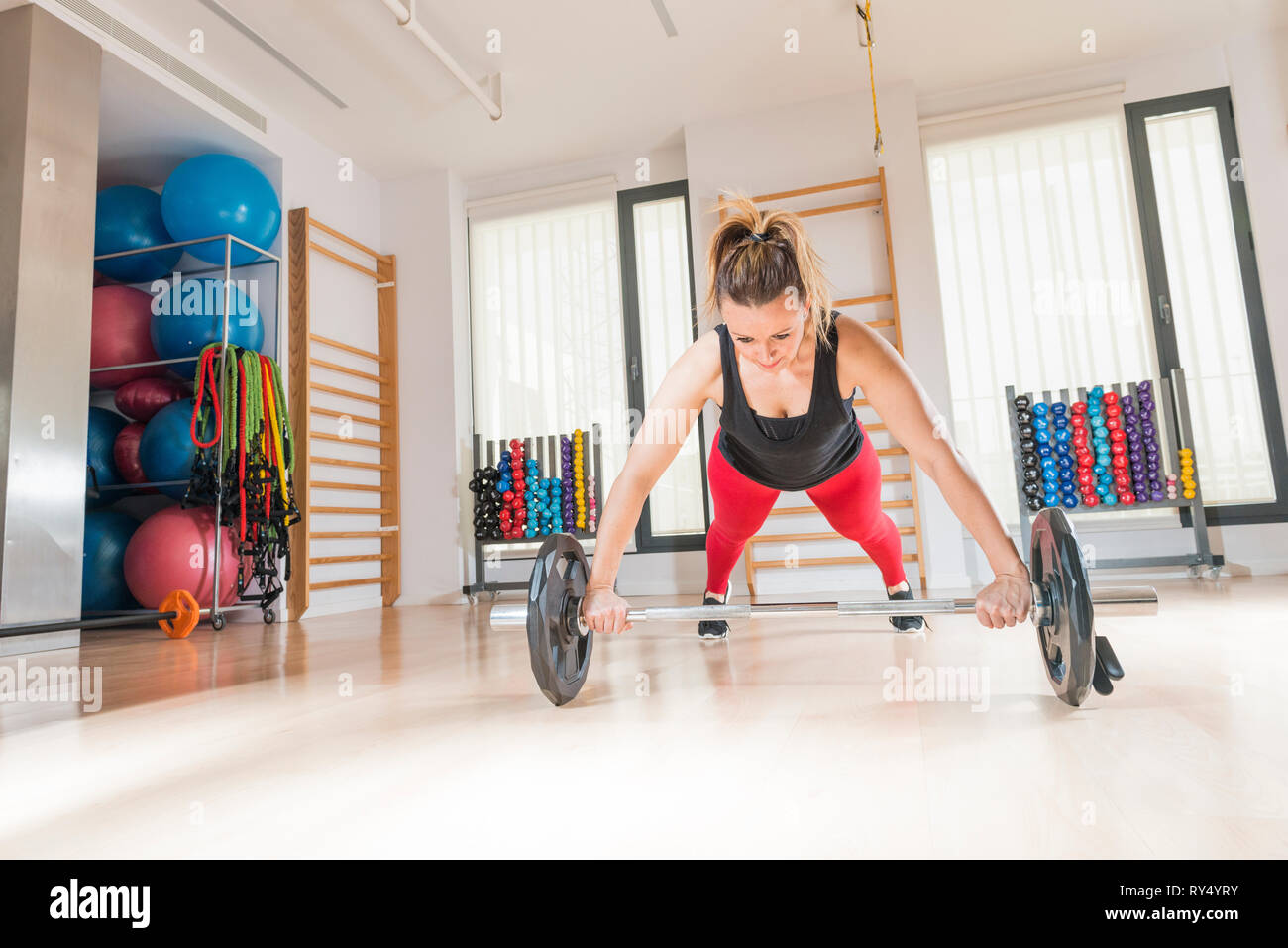 Middle-aged woman (40-45 years old) practicing fitness in a gym Stock ...