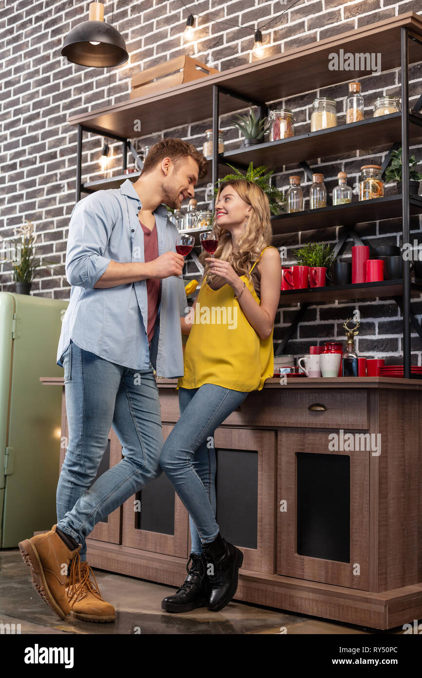 Just married couple wearing stylish casual clothes drinking wine at ...