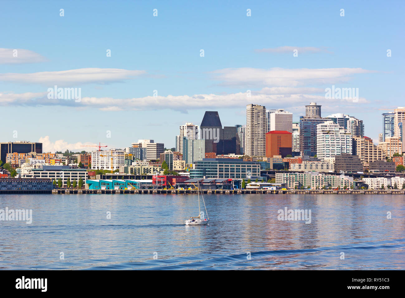 A motorboat in Puget Sound bay waters and Seattle downtown on ...