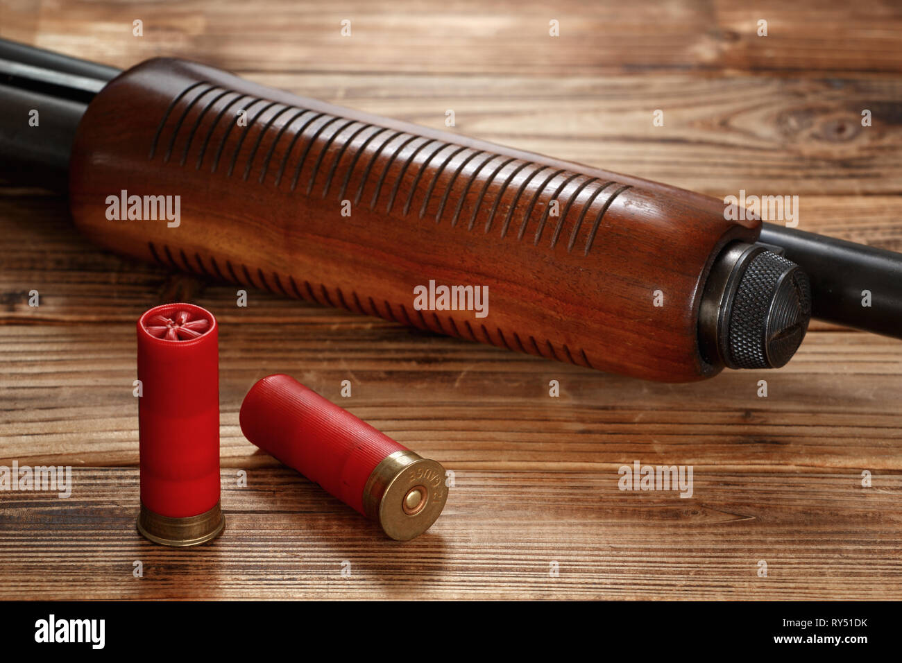 12 gauge pump action shotgun and shells on wood Stock Photo - Alamy