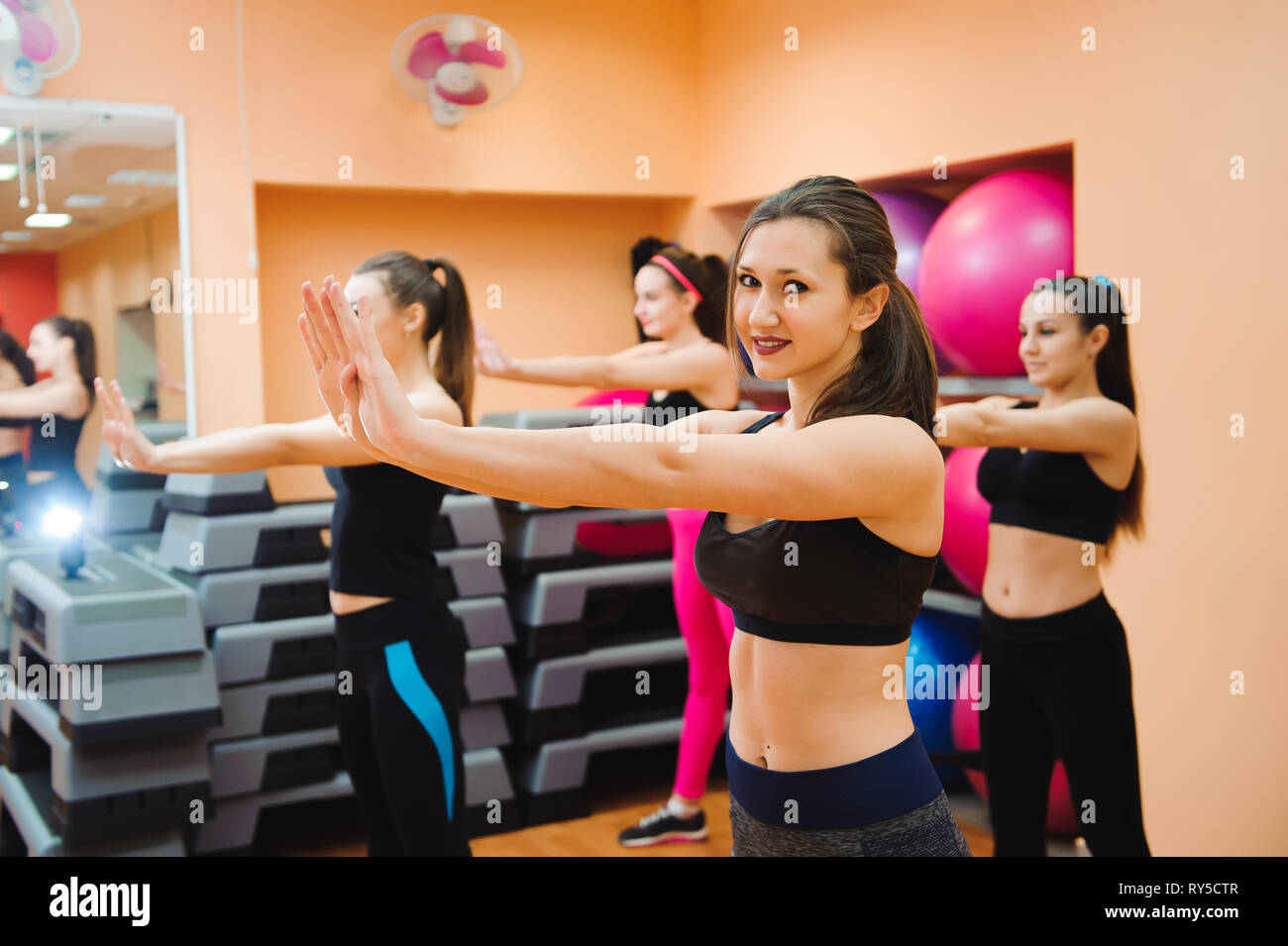 Beautiful women exercising aerobics in fitness club Stock Photo - Alamy