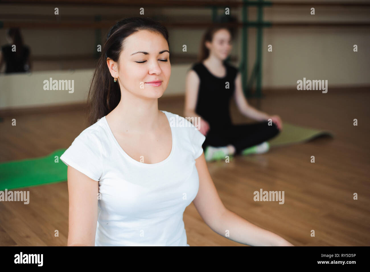 athletic woman doing relaxation exercises in gym class Stock Photo - Alamy