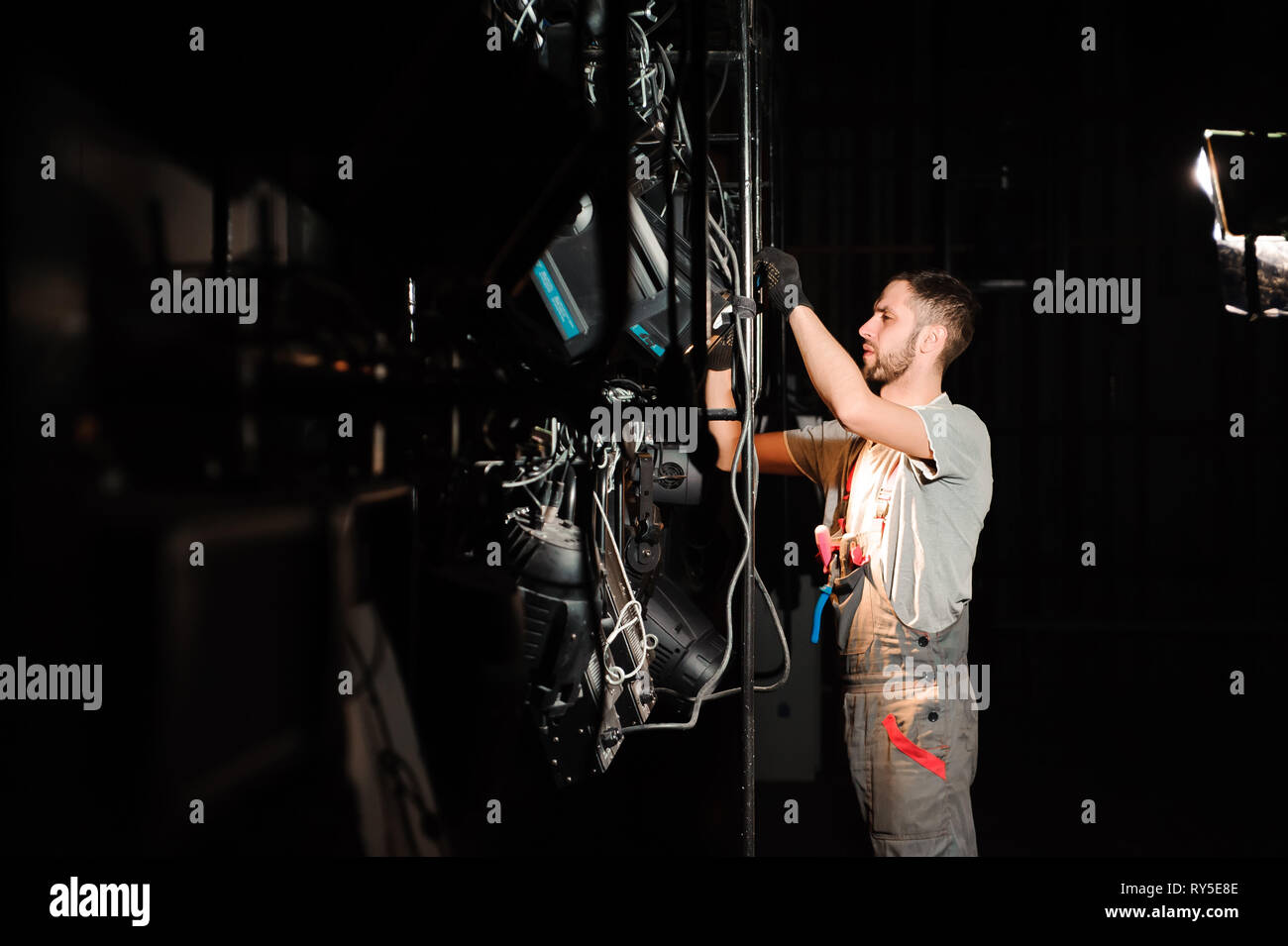 The lighting engineer adjusts the lights on stage behind the scenes ...