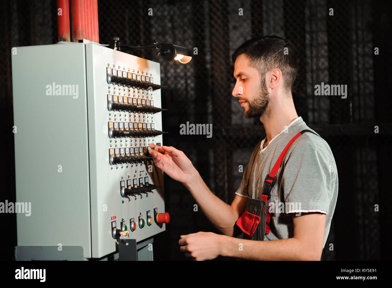 The lighting engineer adjusts the lights on stage behind the scenes ...