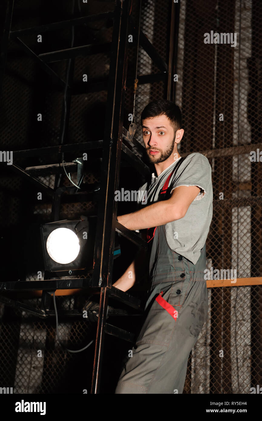 The lighting engineer adjusts the lights on stage behind the scenes ...