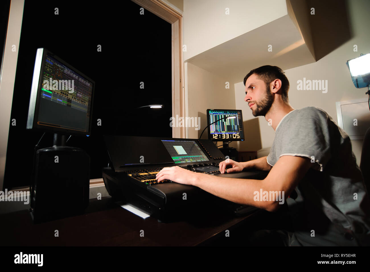 A lighting engineer works with lights technicians control on the ...