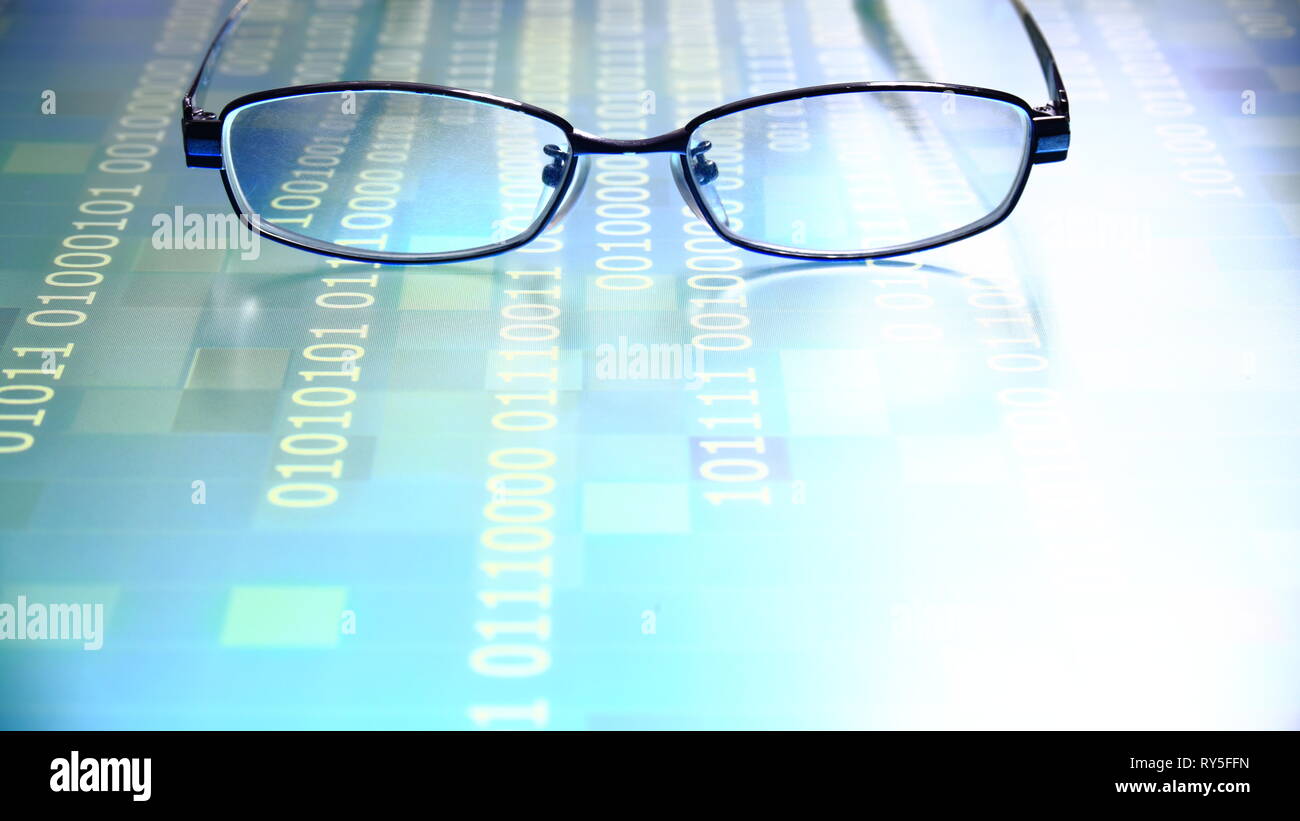 reading data in digital age. glasses and flowing binary code matrix. shallow depth of field ...