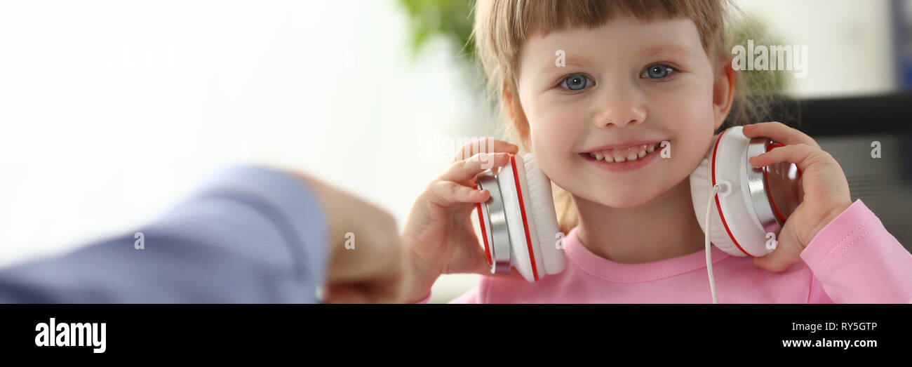 Satisfied child in headphones sitting Stock Photo - Alamy