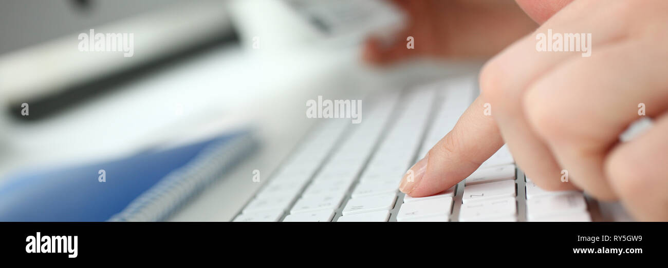 Female arms hold credit card press buttons Stock Photo - Alamy