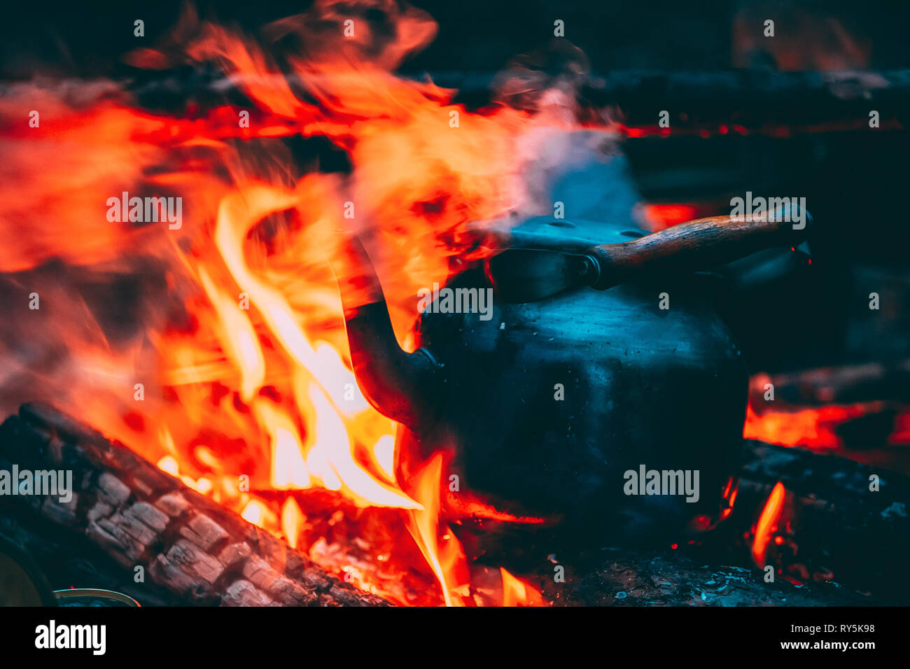 Old Retro Iron Camp Kettle Boiling Water On A Fire In Forest. Bright ...