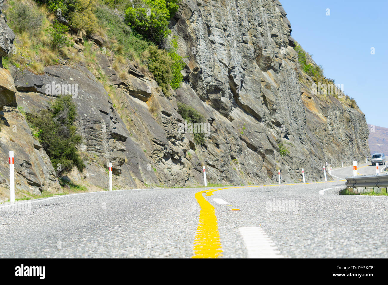 South Island curving highway with yellow no over-taking line through ...