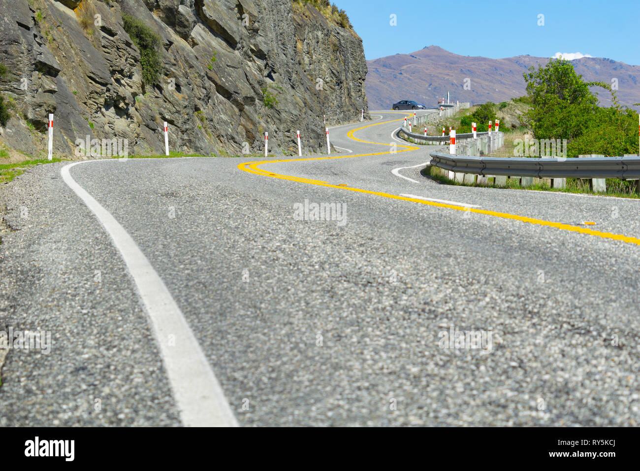 South Island curving highway with yellow no over-taking line through ...