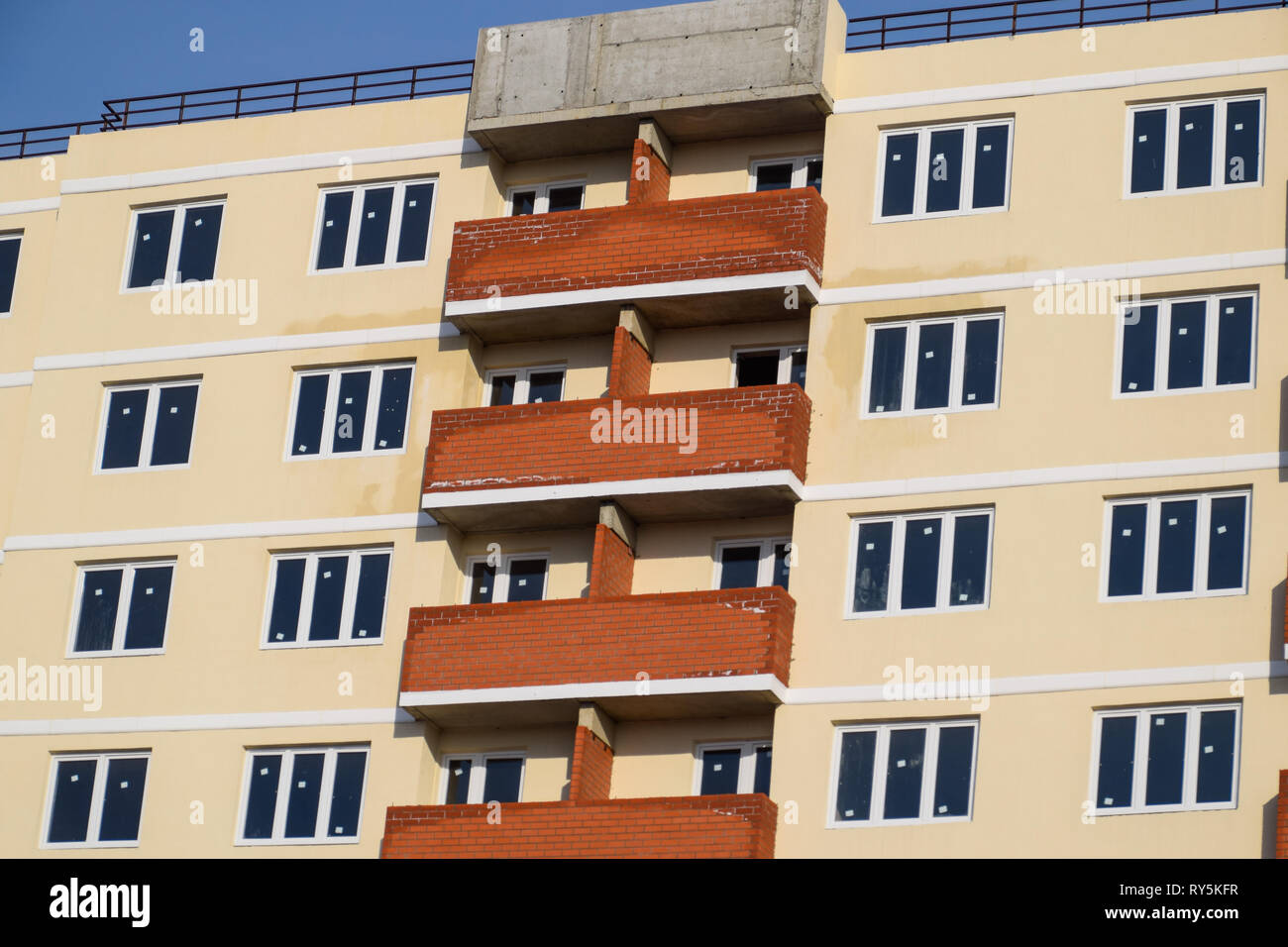 wall of a high-rise brick house, red balconies and yellow walls Stock ...