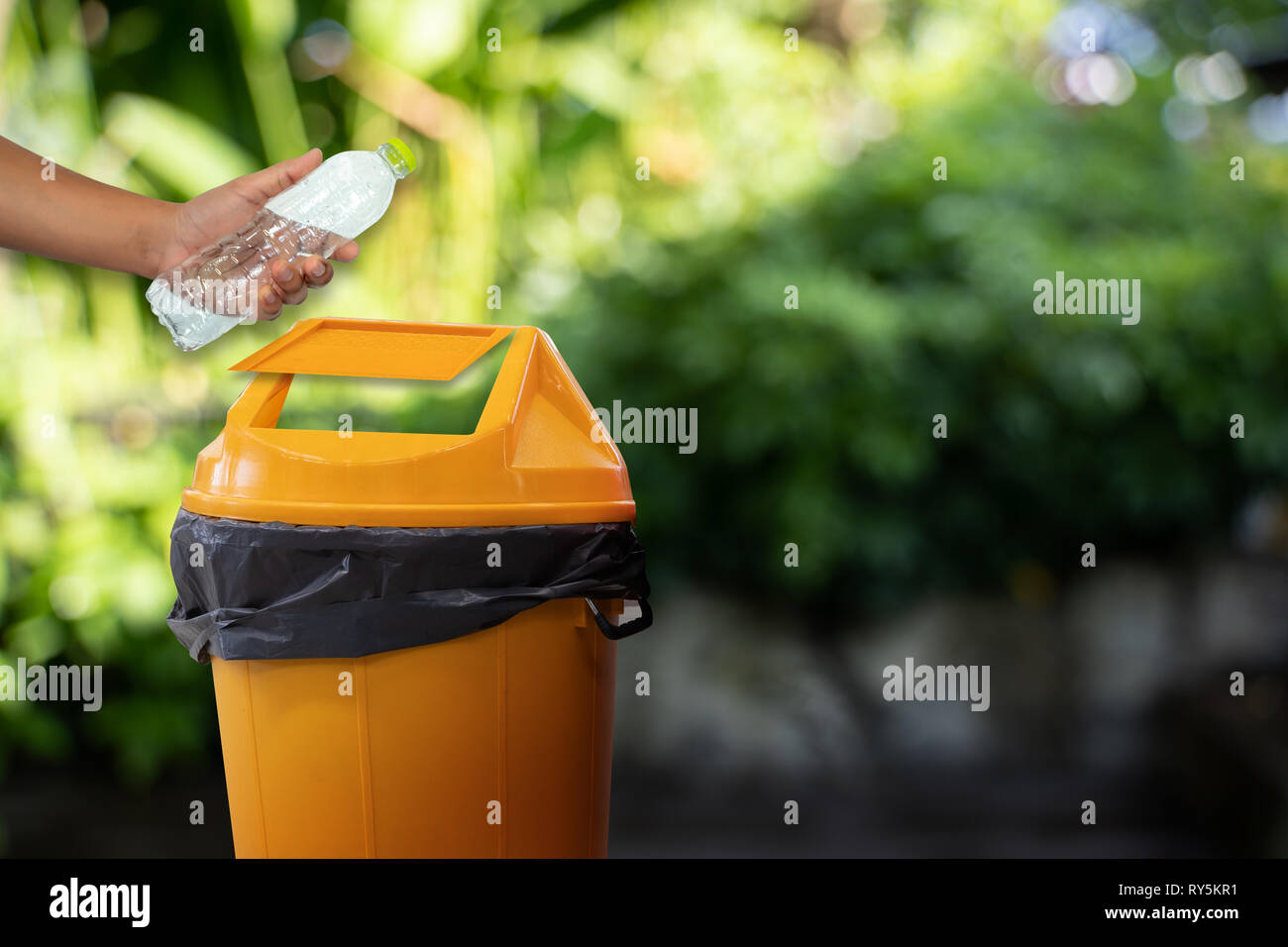 man hand putting plastic reuse for recycling concept environmental ...