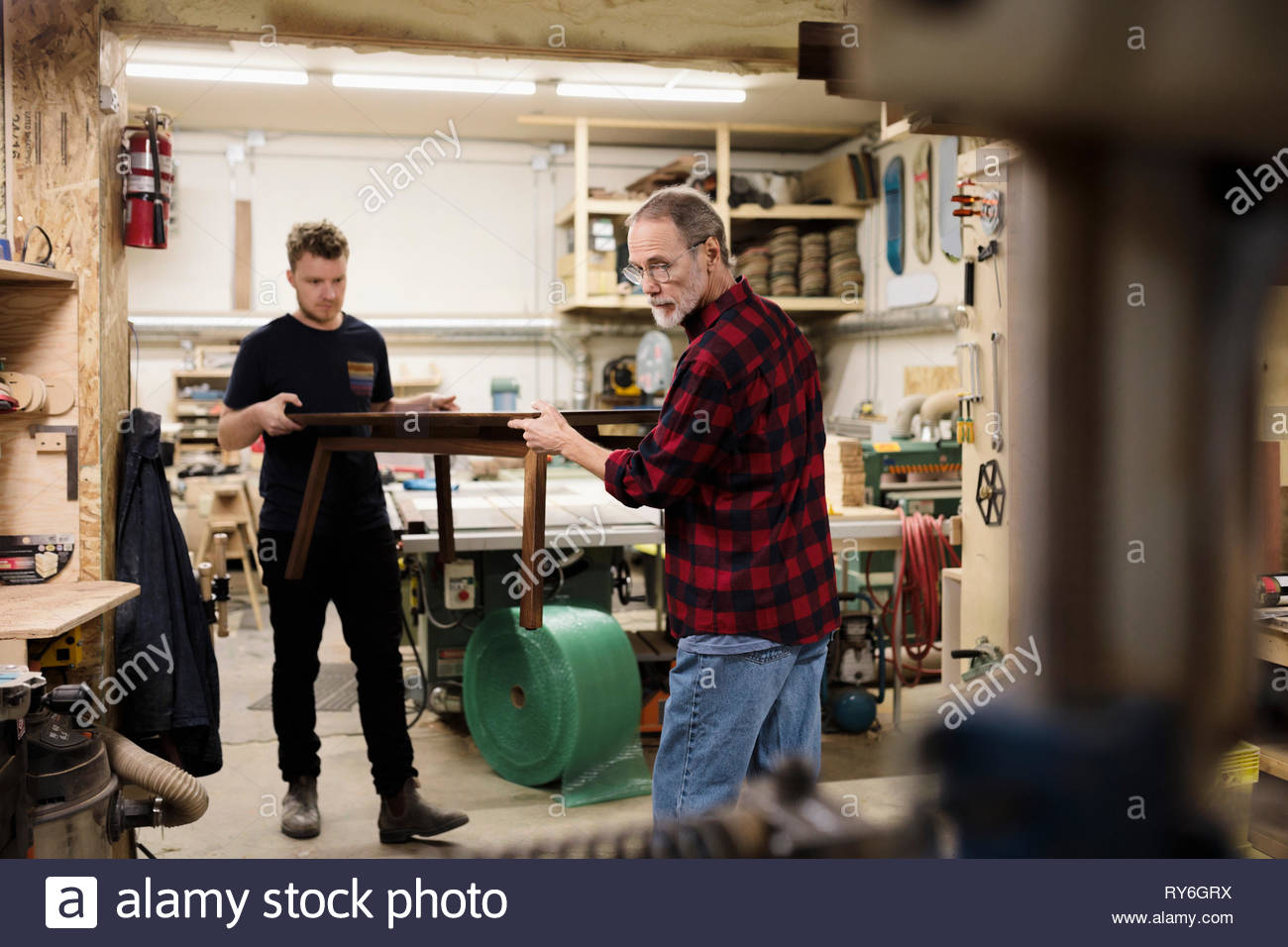 Two men carrying furniture hi-res stock photography and images - Alamy