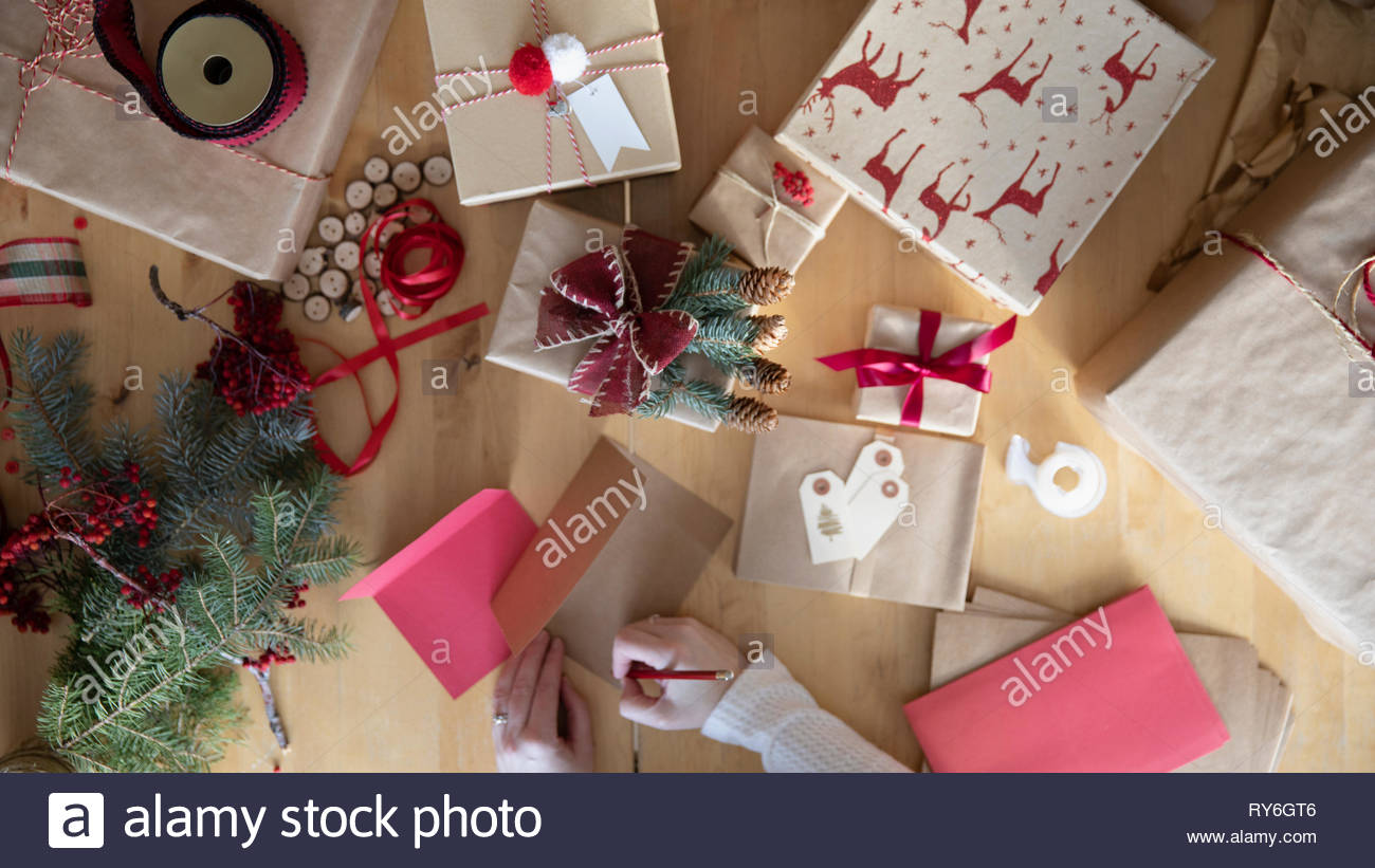 View from above woman wrapping christmas gifts Stock Photo - Alamy