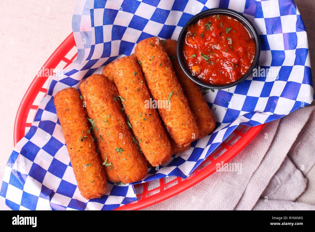 High angle view of cheese sticks with sauce served in plate on table ...