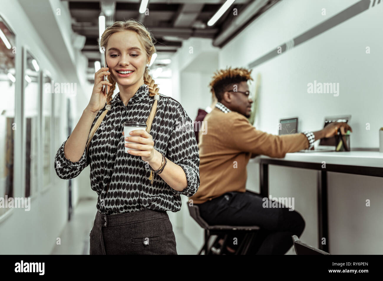 Good-looking pleasant young woman having call at work Stock Photo - Alamy
