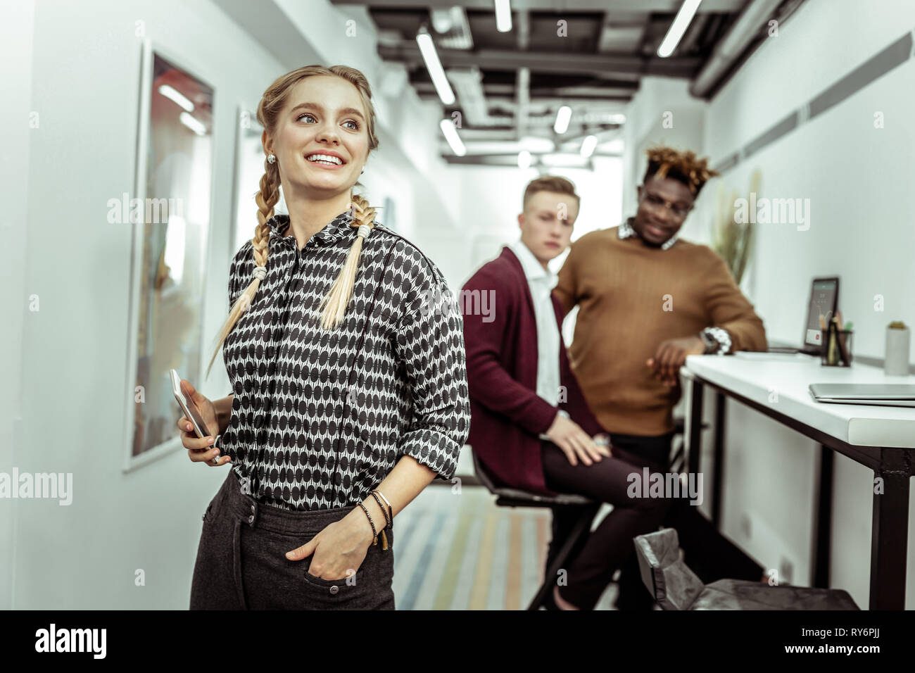 Two interested guys checking their female workmate from behind Stock ...