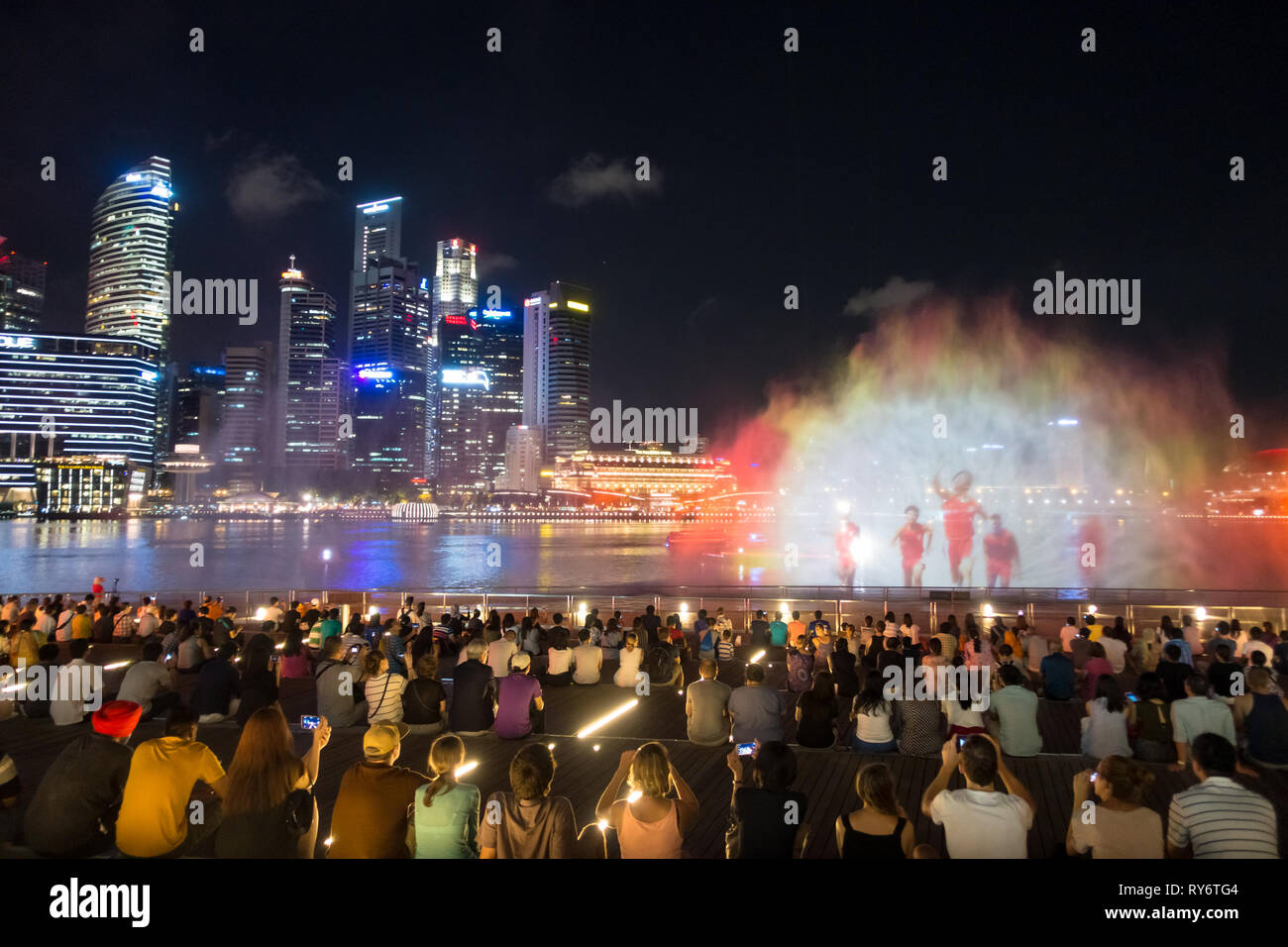 Water projection show and audience at Marina Bay, Singapore Stock Photo ...
