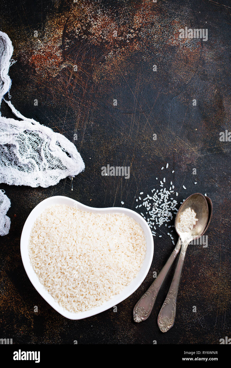 raw rice in bowl plate, rice in heart-shaped bowl Stock Photo - Alamy
