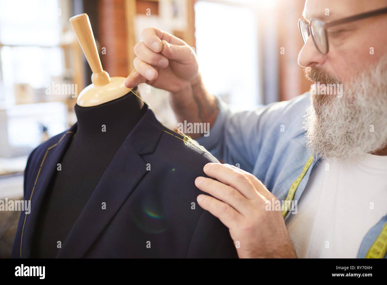 Man sewing jacket Stock Photo - Alamy